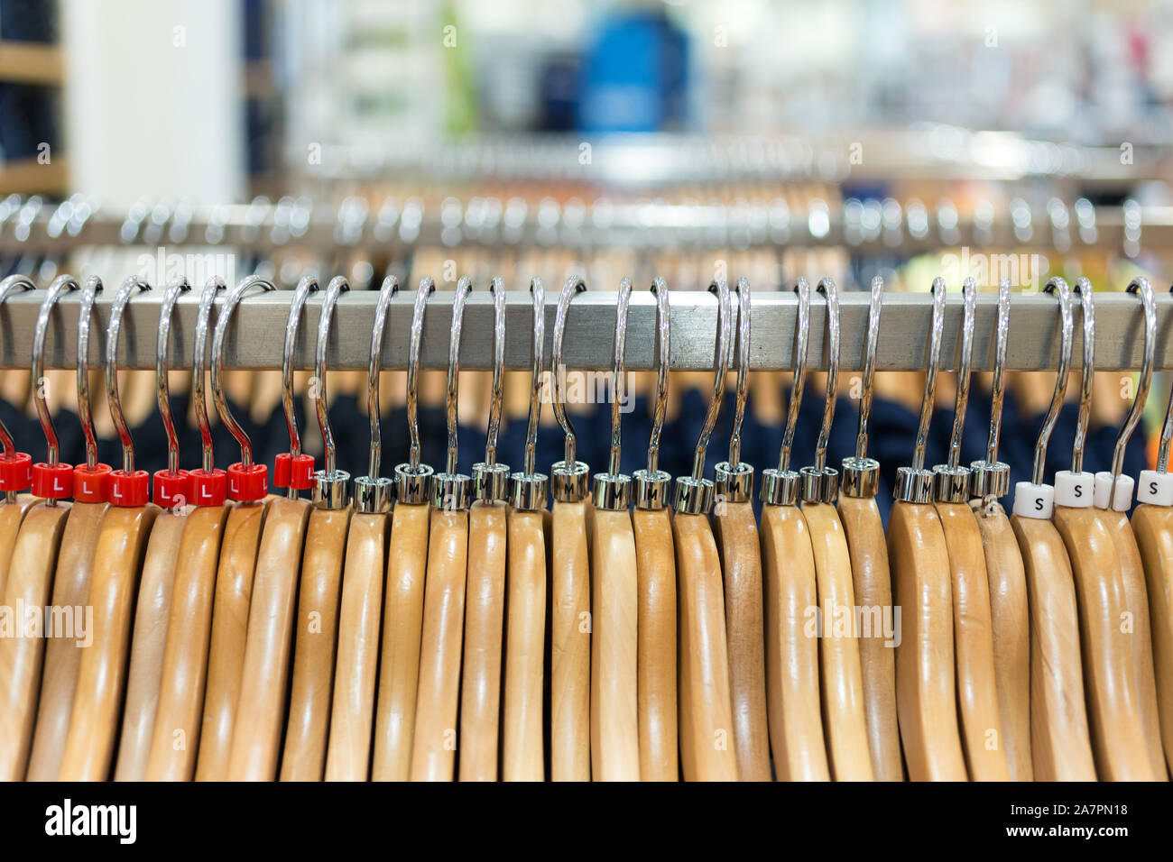 Rows of clothes hangers rack, close up Stock Photo - Alamy