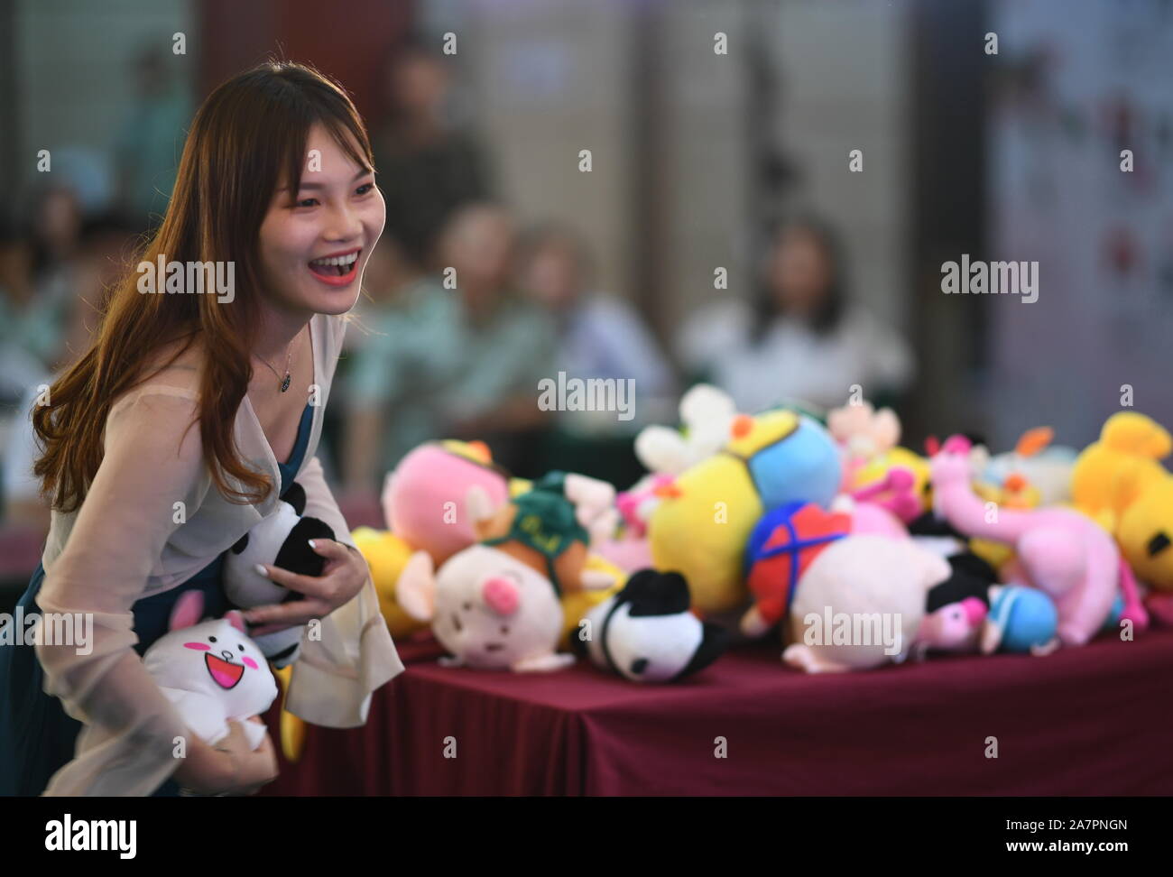 A woman is throwing stuffed animals during the match-making event in ...