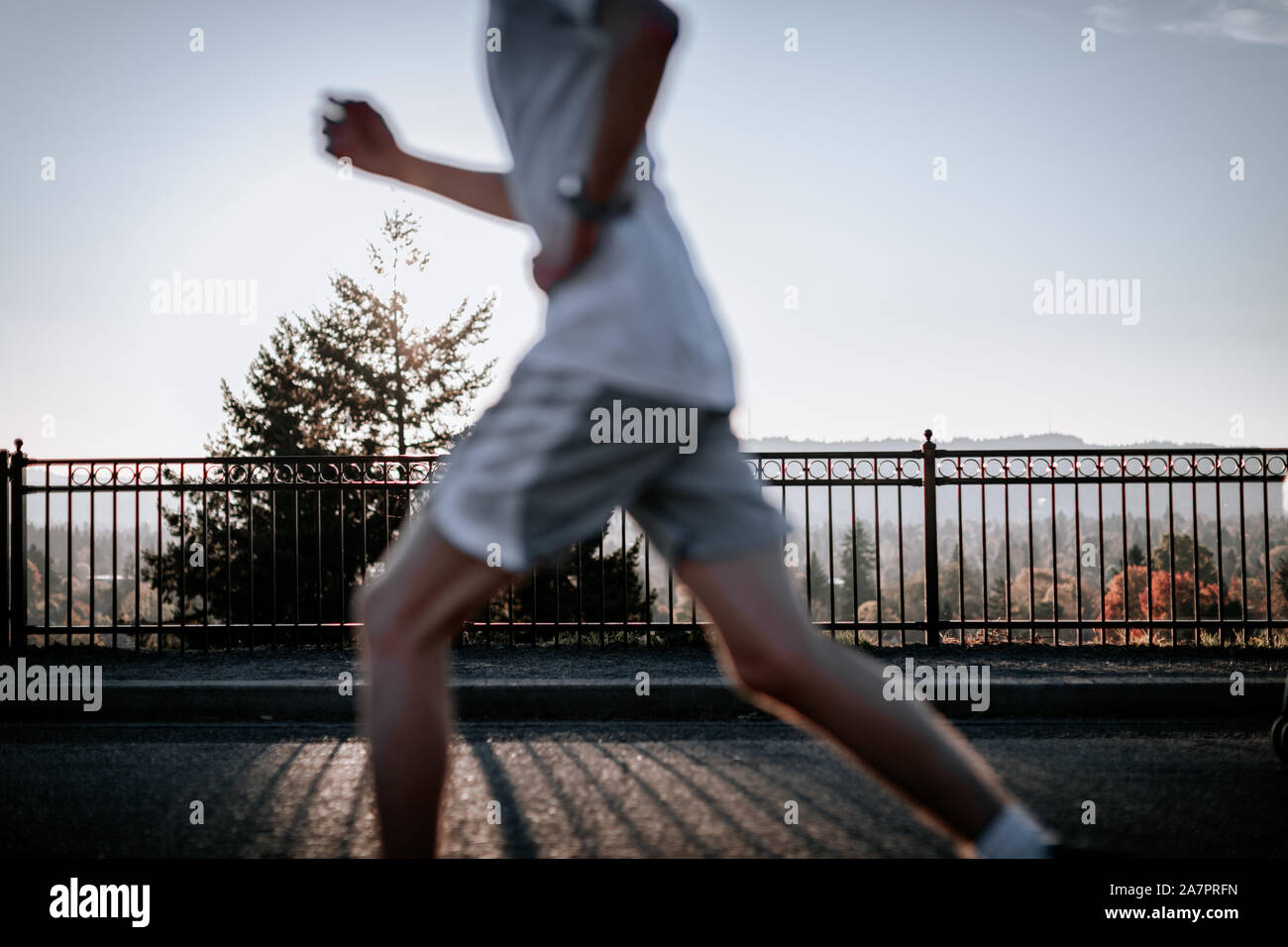 Man running jogging in the sunset autumn park Stock Photo - Alamy
