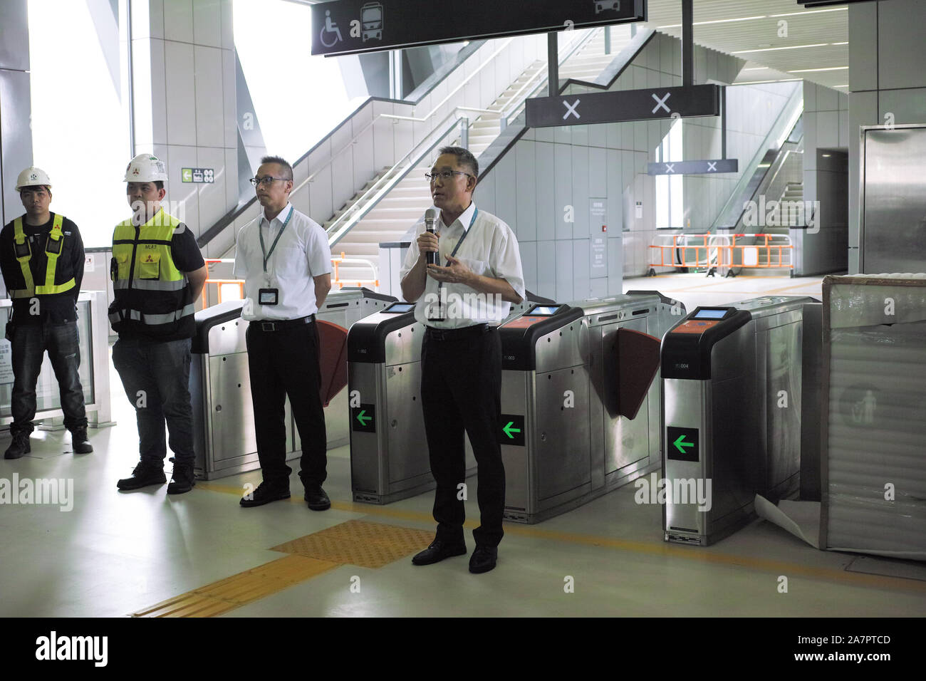 Chinese workers introduce the Light Rail Transit (LRT) system at the ...