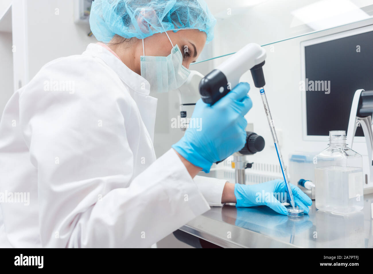 Scientist in lab conducting biotechnological experiment Stock Photo - Alamy