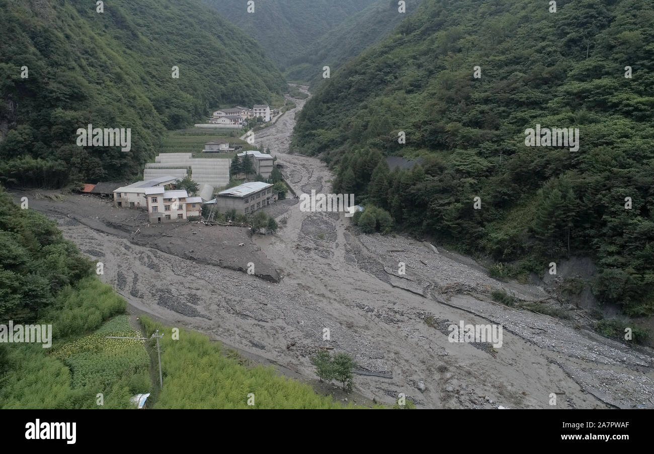 Residential buildings are covered with mud and stones after being hit ...