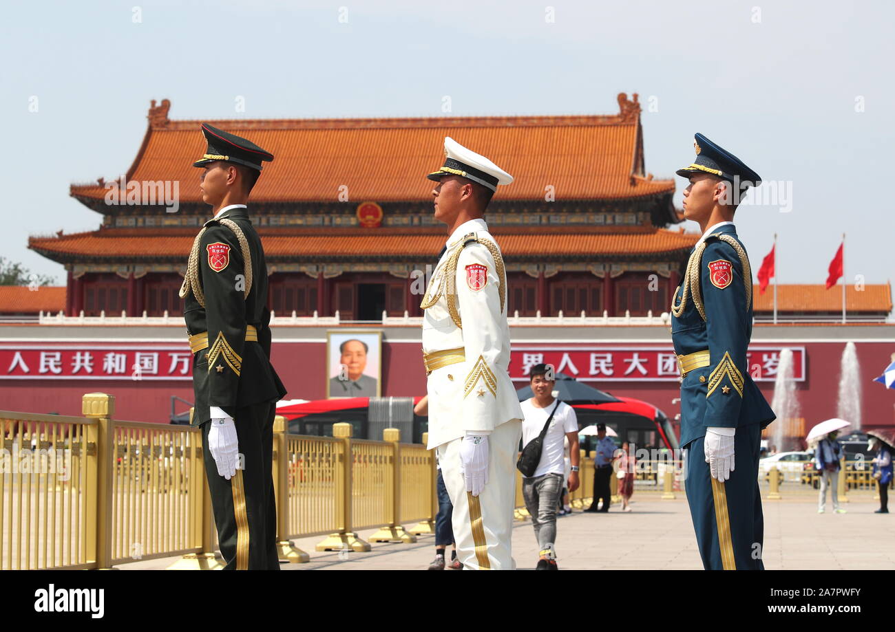 A soldier, a sailor and an airman patrol at the Tian'anmen Square to ...