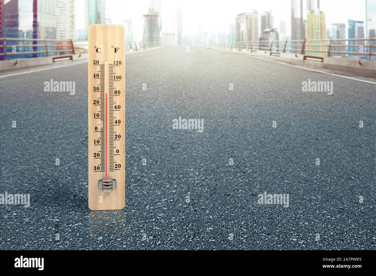 Thermometer measuring the temperature on the city with skyscrapers ...