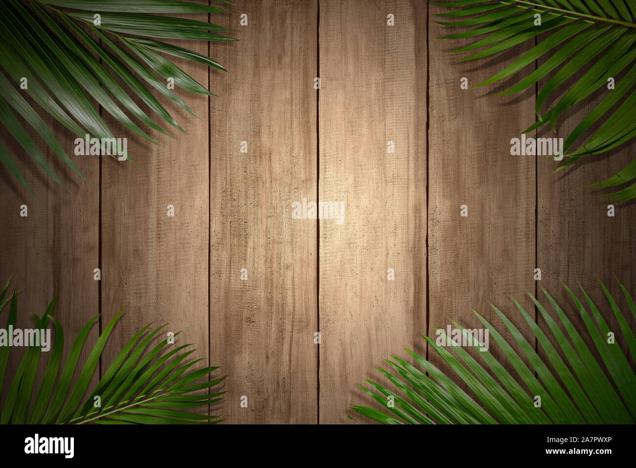 Green palm leaf on wooden table background Stock Photo - Alamy