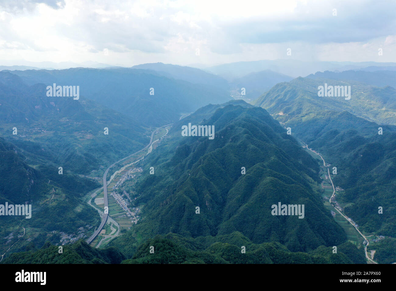The view of mountains and river with village bungalows scattering ...