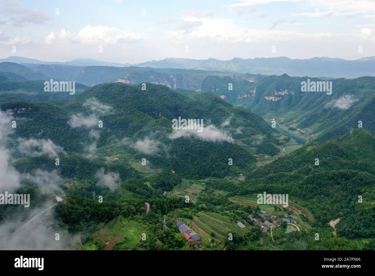 The view of mountains and river with village bungalows scattering ...