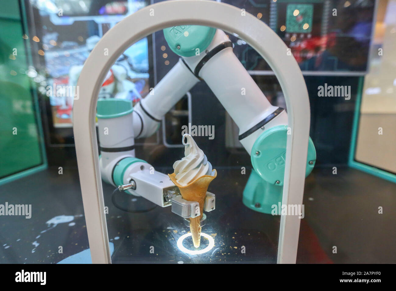 A robot arm makes an ice cream for customers at a fastfood restaurant ...
