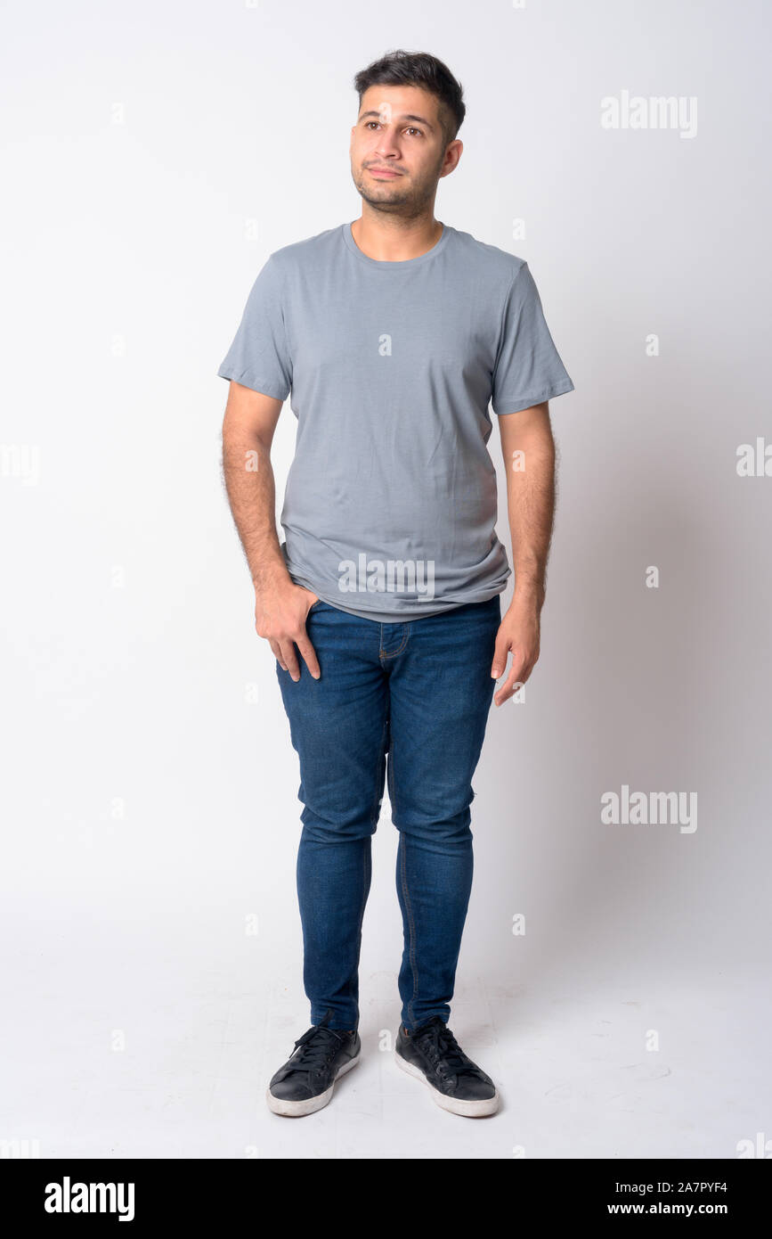 Full body shot of young Persian man thinking Stock Photo - Alamy
