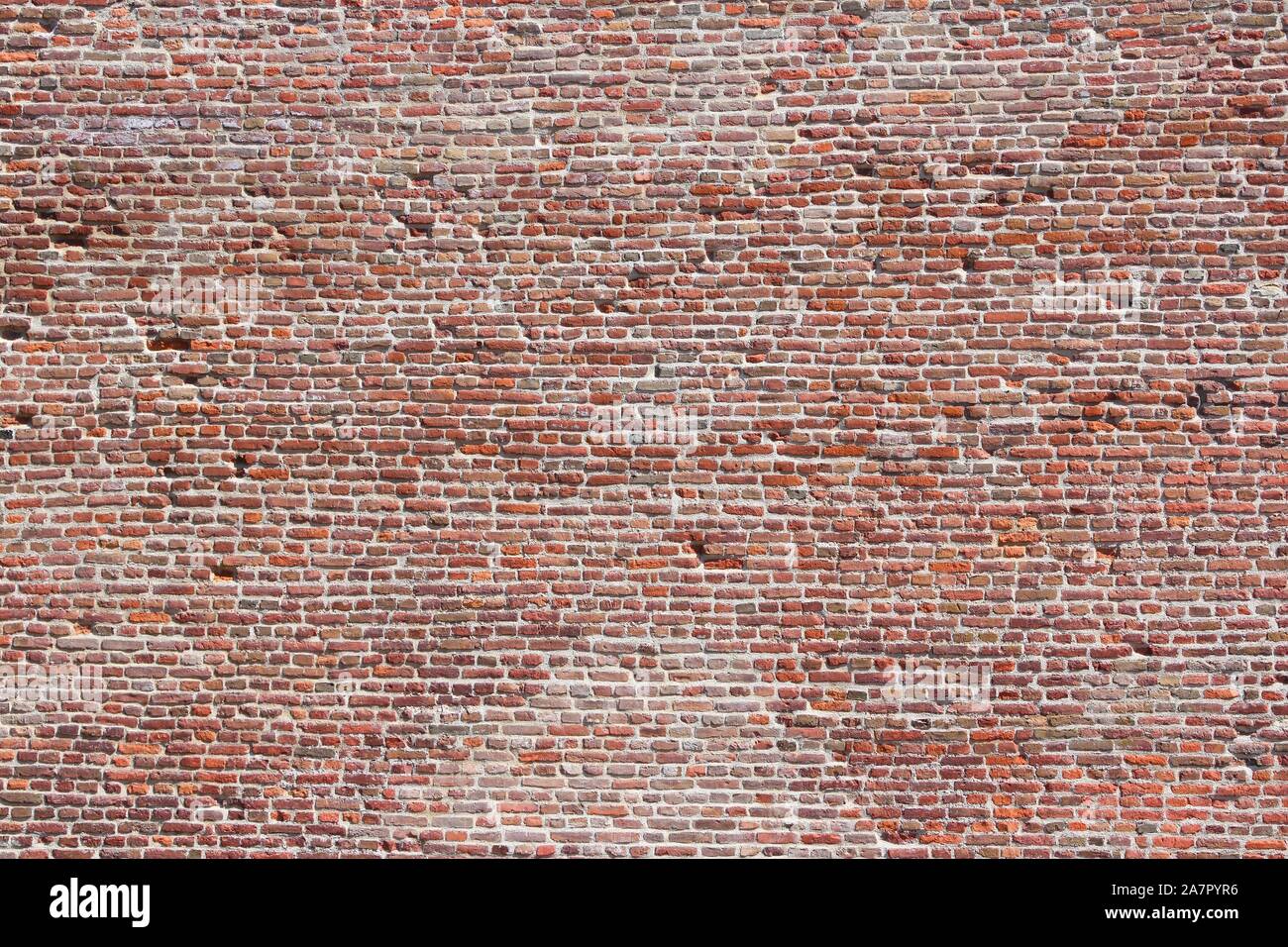 Brick wall background - old aged red bricks Stock Photo - Alamy