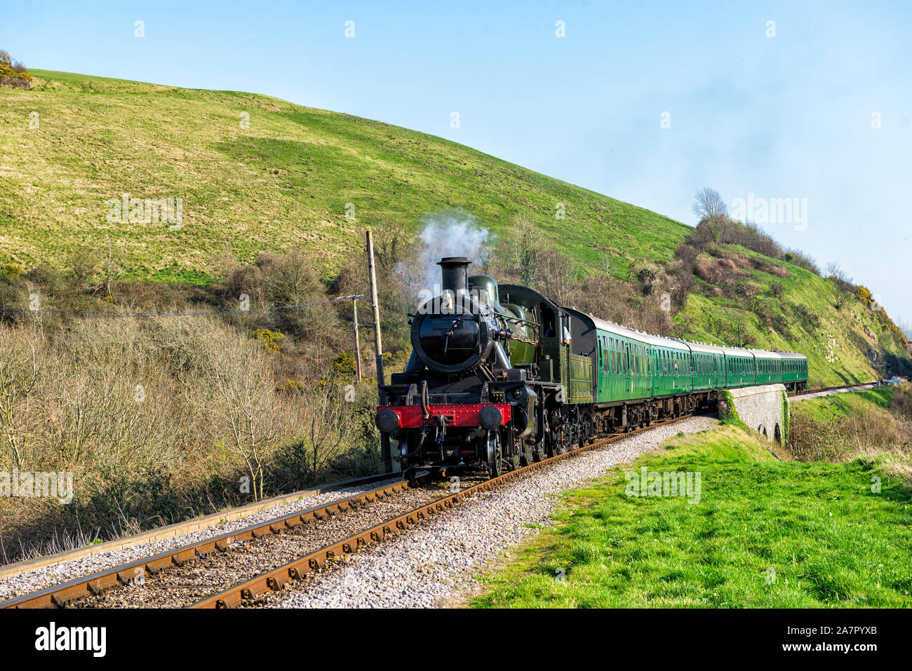 Steam Train Moving Swiftly through the Country Hills Stock Photo - Alamy