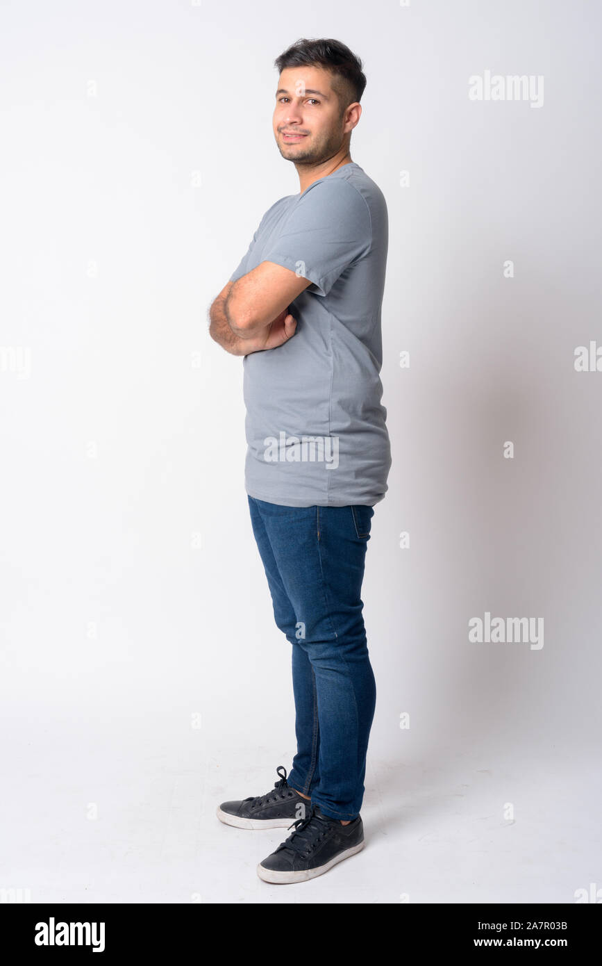 Full body shot profile view of happy young Persian man smiling with ...