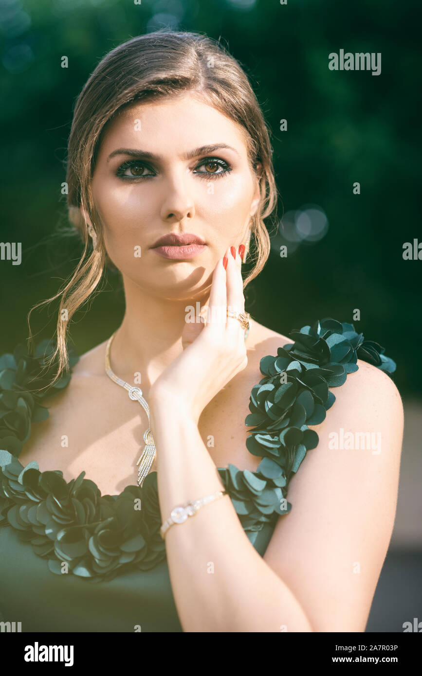 Worried beautiful woman hand touching face looking away outdoors Stock ...