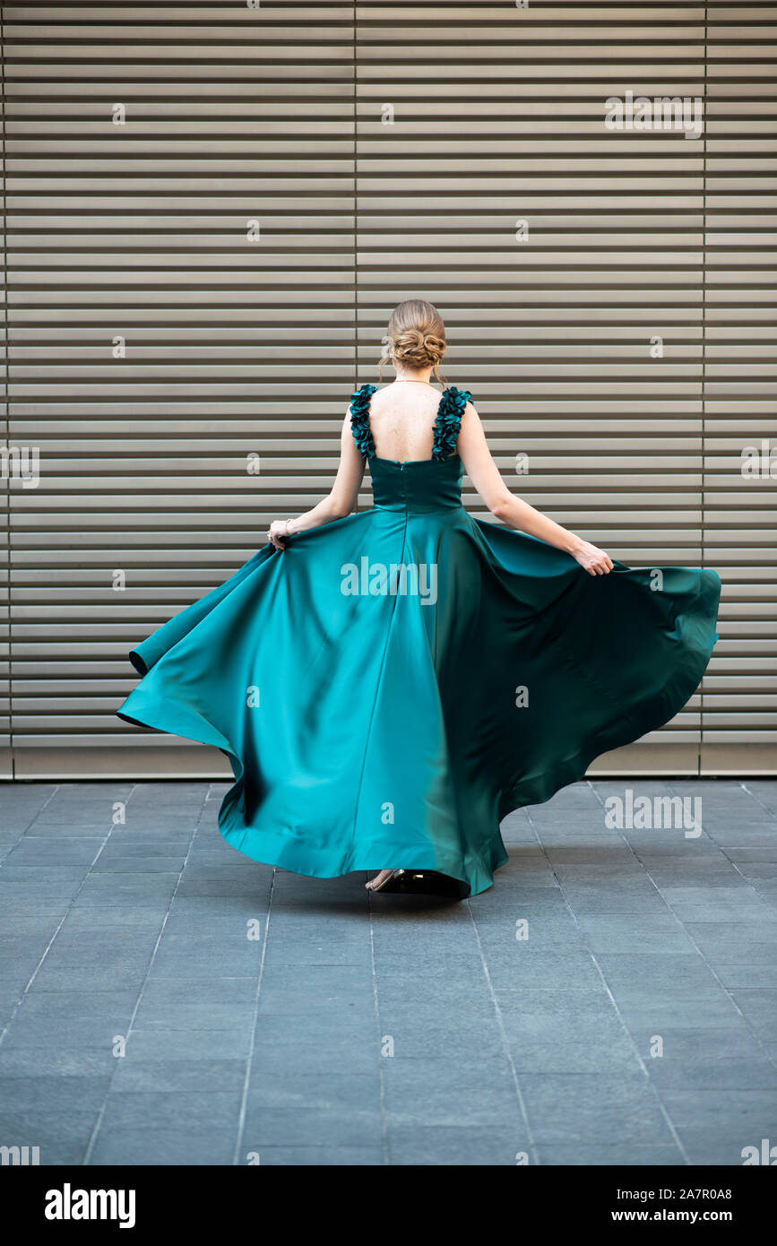 Woman dancing with her hands behind her back hi-res stock photography ...