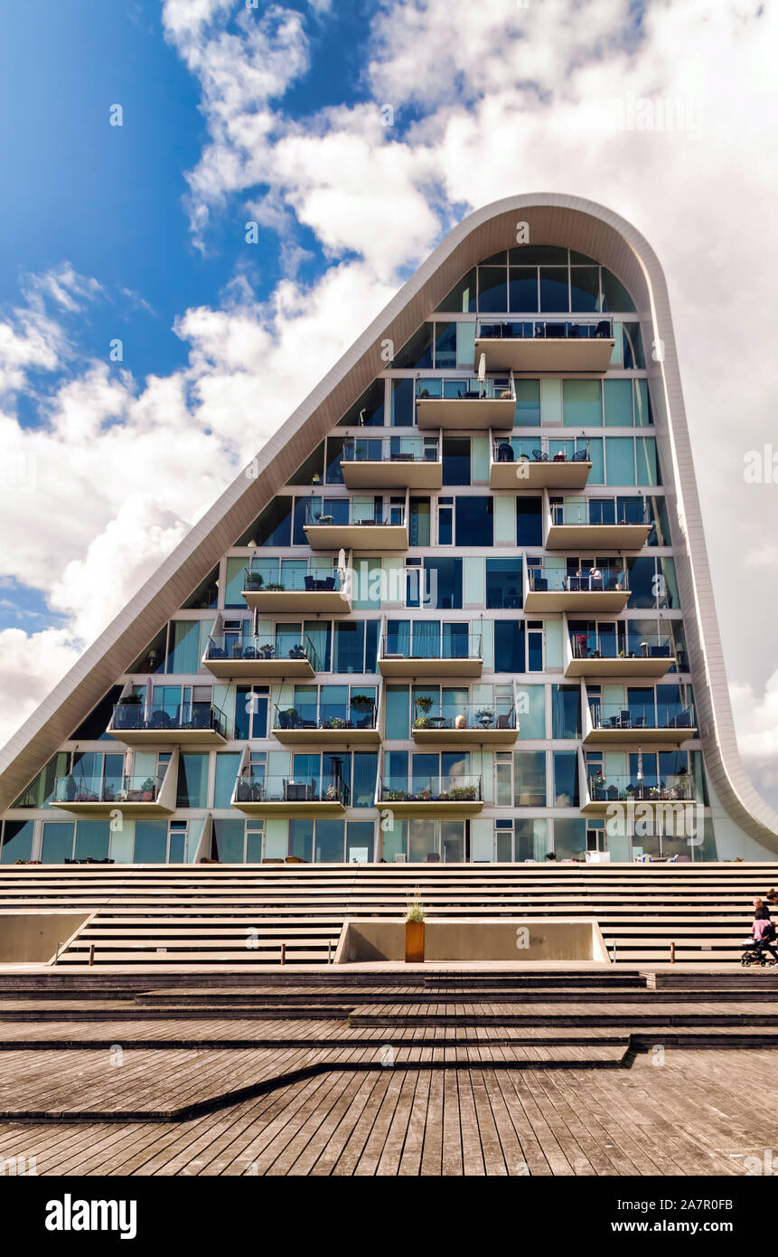 Low angle view of The Wave building against sky. Architect: Henning ...