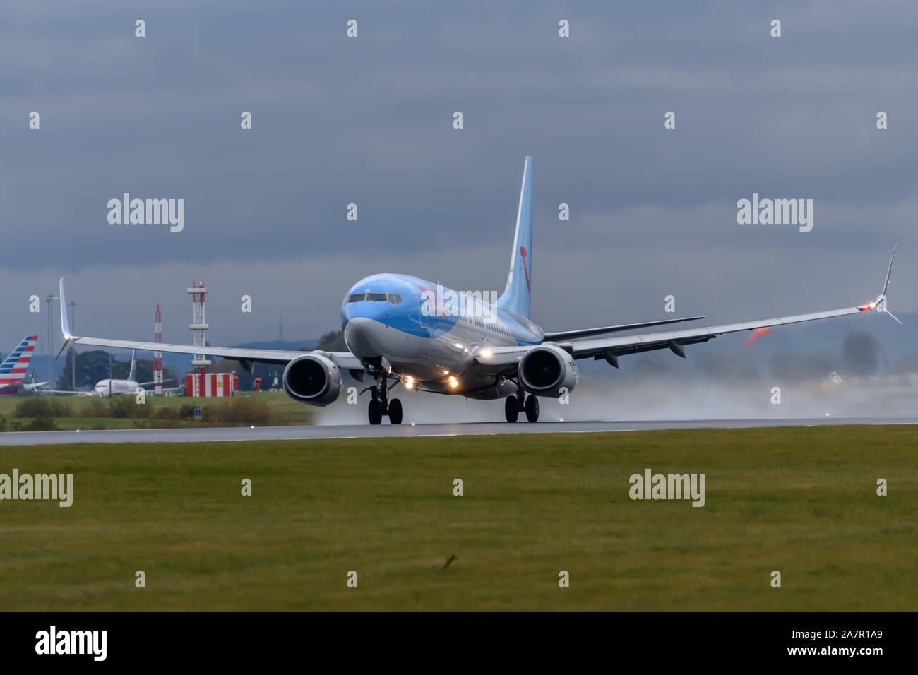 TUI Airline Boeing 737 departing Manchester Airport in the wet Stock ...
