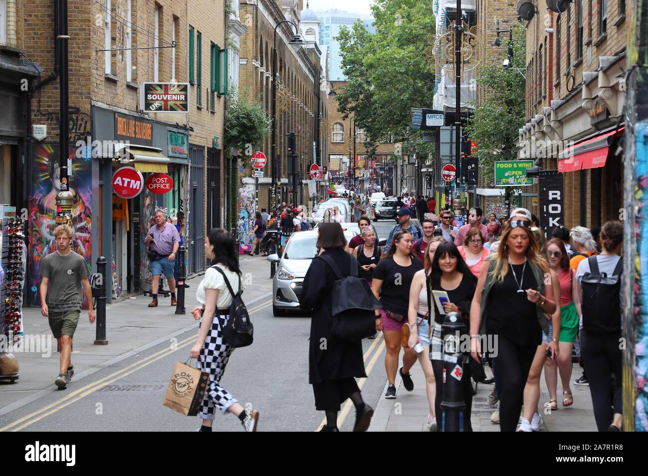 LONDON, UK - JULY 13, 2019: People visit Brick Lane street in ...