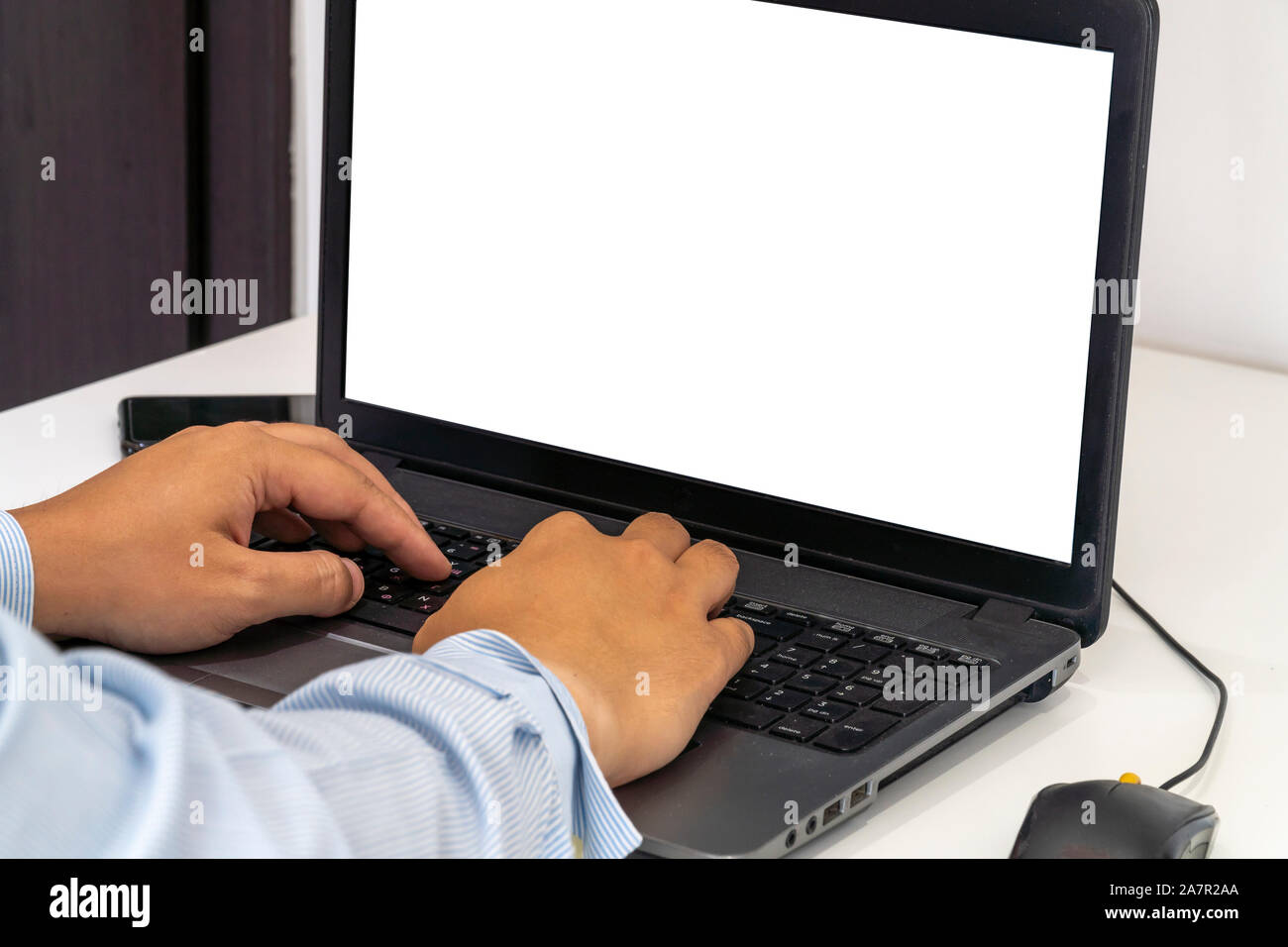Person working on a laptop in a business office enviroment. Over the ...