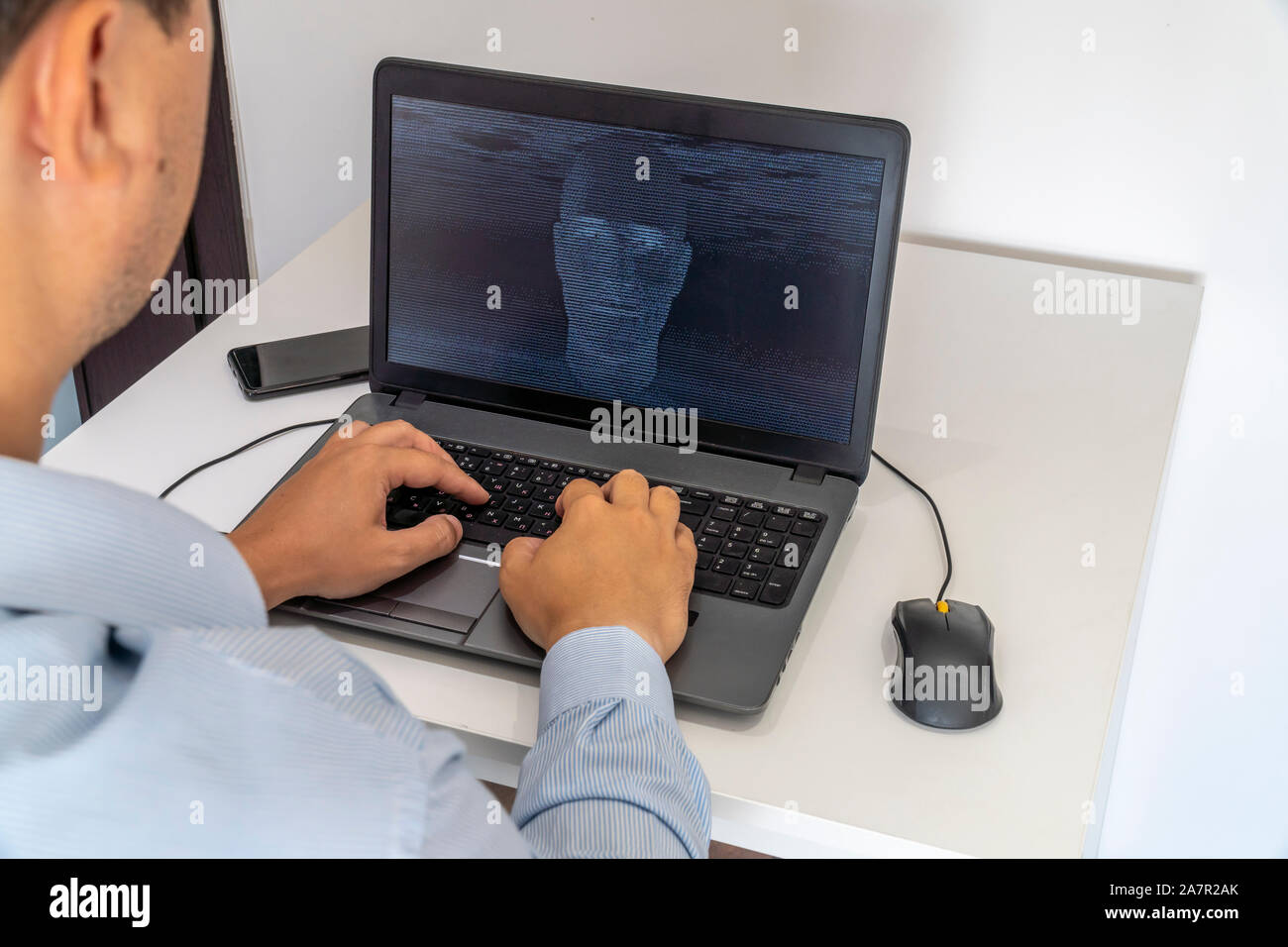 Developer coding on a laptop and creating a artificial intelligence ...