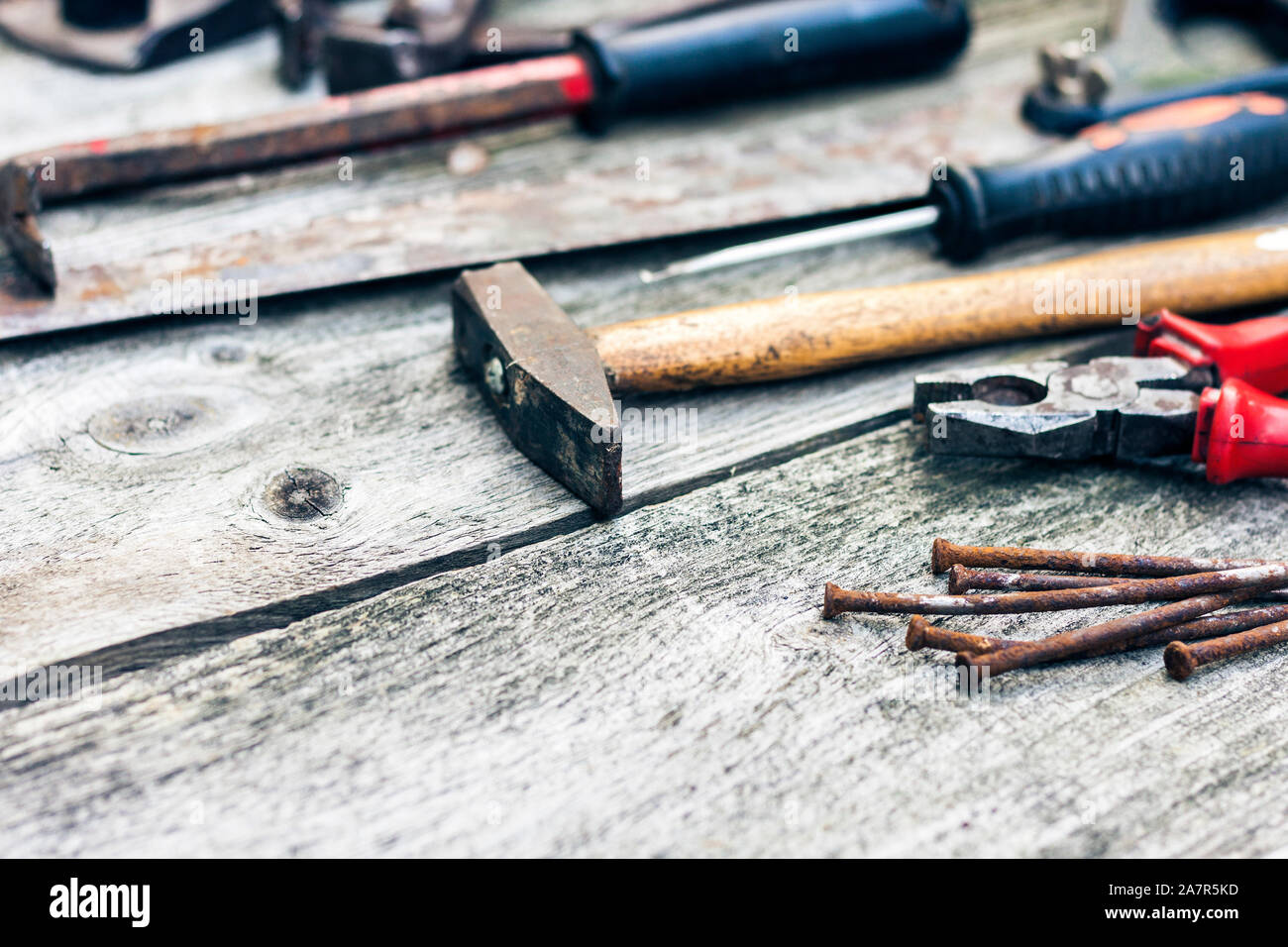 Set of vintage hand construction tools hammers on a wooden background ...