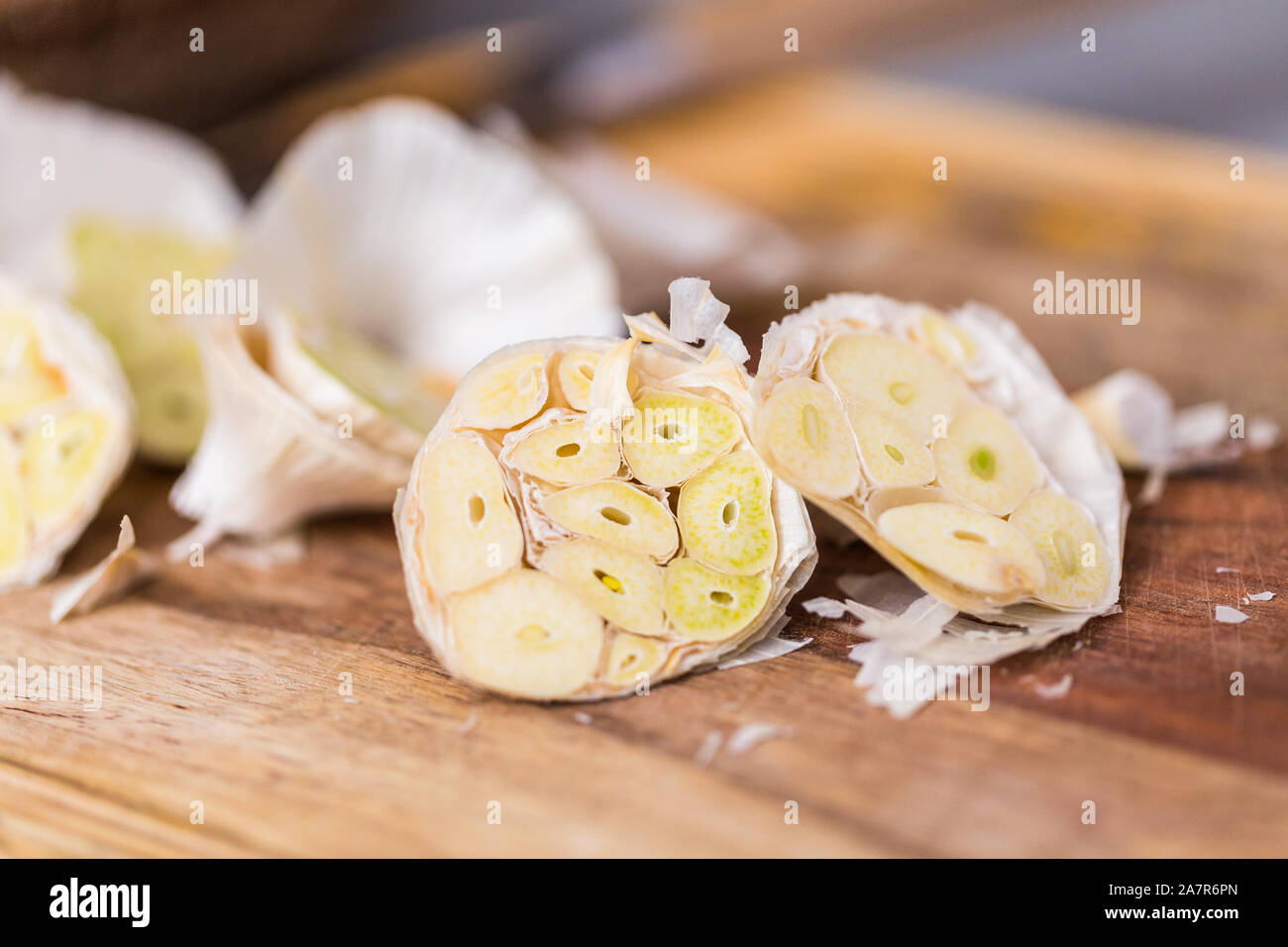 Cutting garlic heads to preapre roasted garlic spread Stock Photo - Alamy