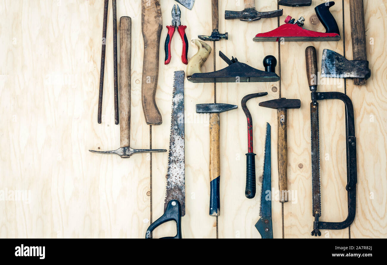 Set of vintage hand construction tools hammers on a wooden background ...