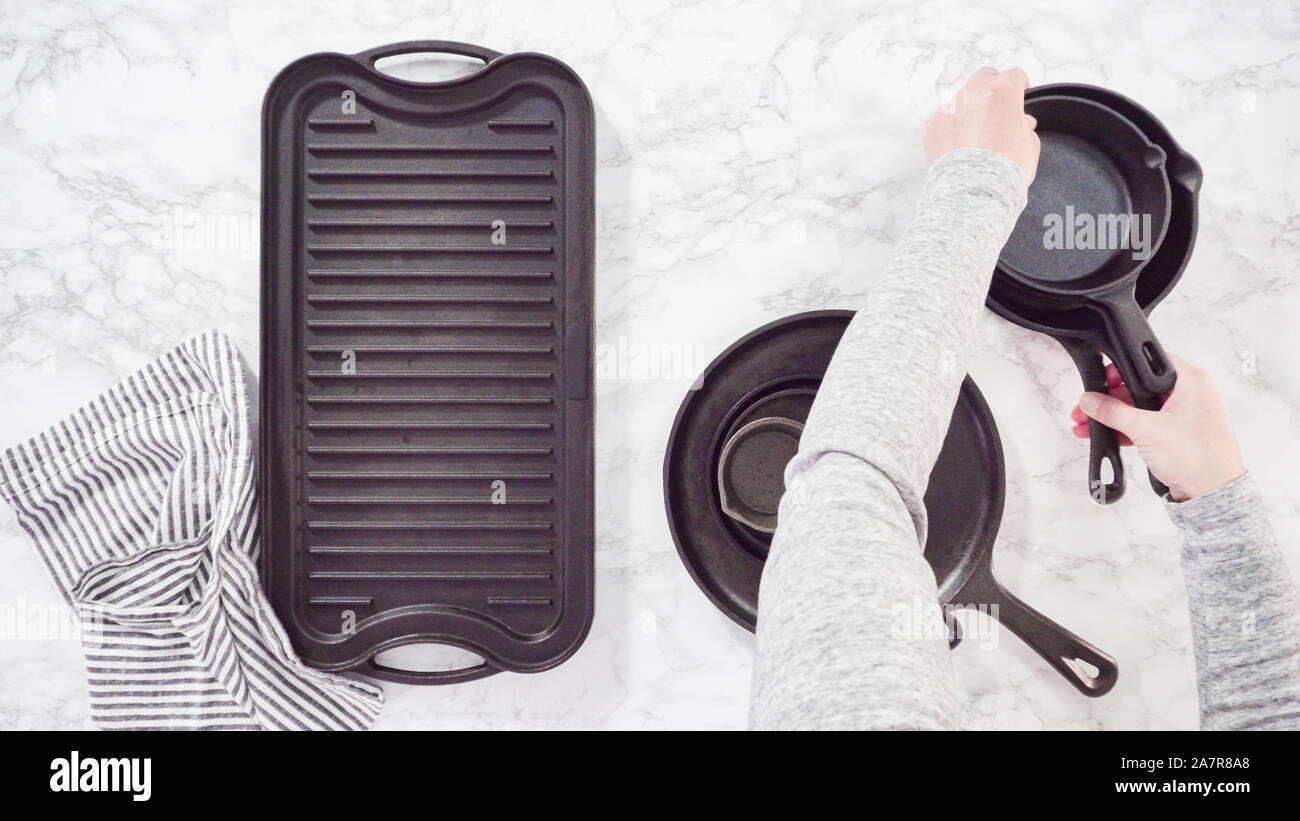 Flat lay. Variety of cast iron kitchenware on a marble countertop Stock ...