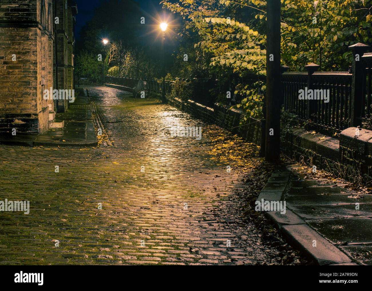 The cobbled streets of Saltaire shimmer in the lamplight looking like ...