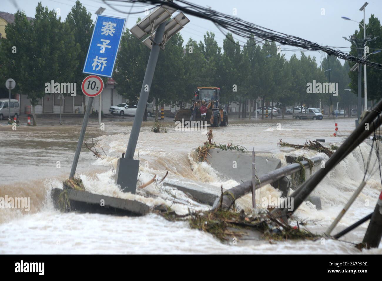 A bridge is devastated by the floodwater due to rainstorms caused by ...