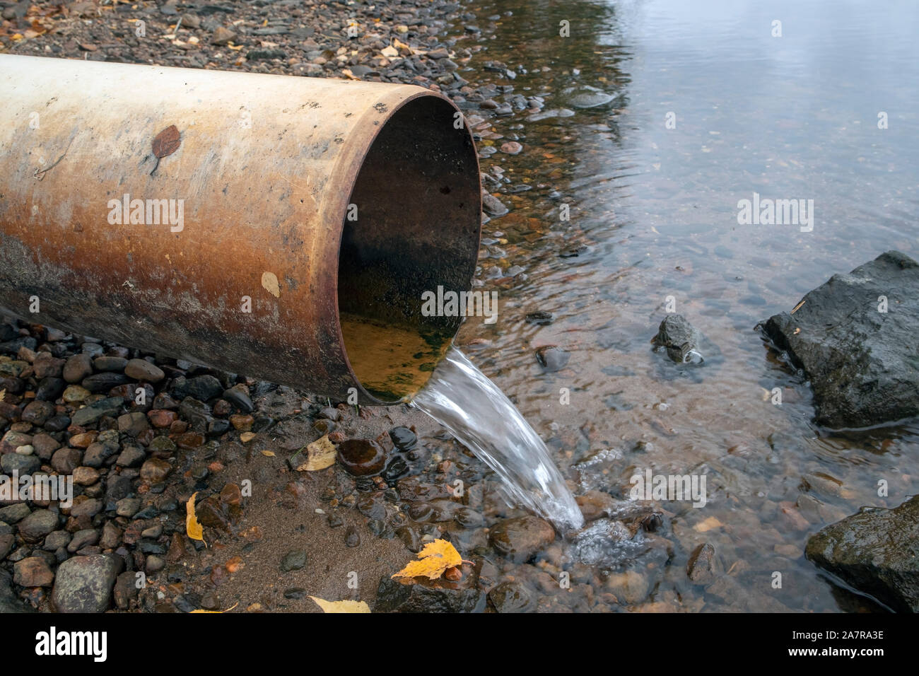water running out of drain pipe into lake, Finland Stock Photo - Alamy