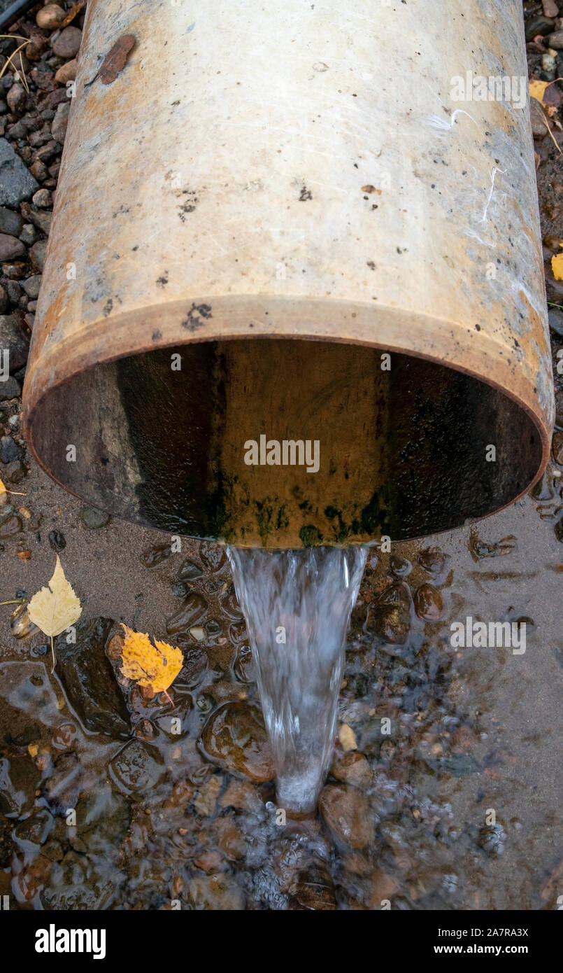 water running out of drain pipe into lake, Finland Stock Photo - Alamy
