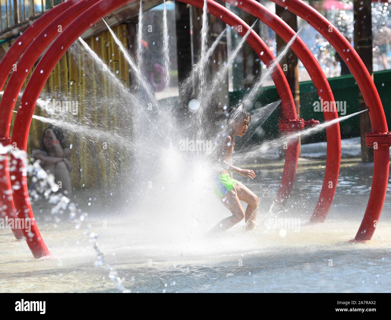 Chinese holidaymakers crowd a swimming pool at a water park to escape ...