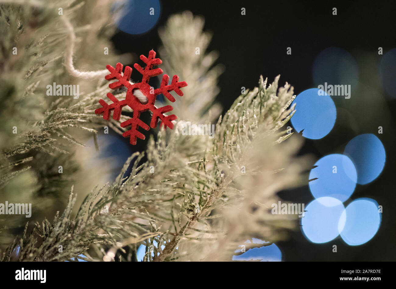 detail of a small, red, wooden snowflake, decorating am indoor ...