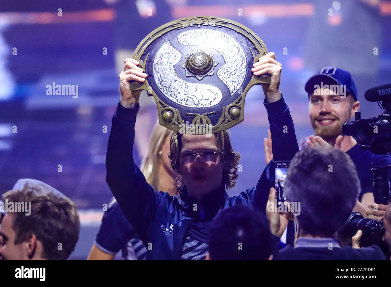 Players of Europe's OG pose for photos with their trophy after winning The International Dota 2 ...