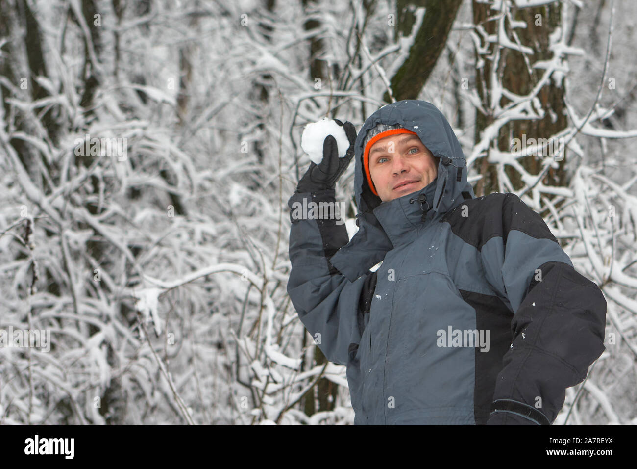 Man throws snowball during snowball fight Stock Photo - Alamy