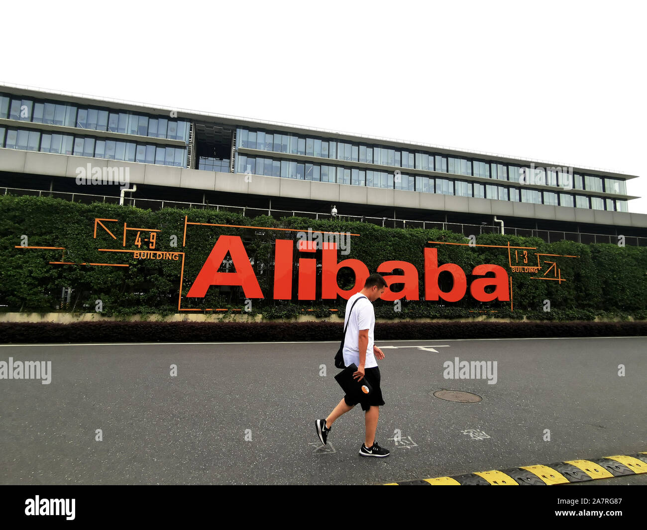 --FILE--A Chinese worker walks at the headquarters of Alibaba Group in ...