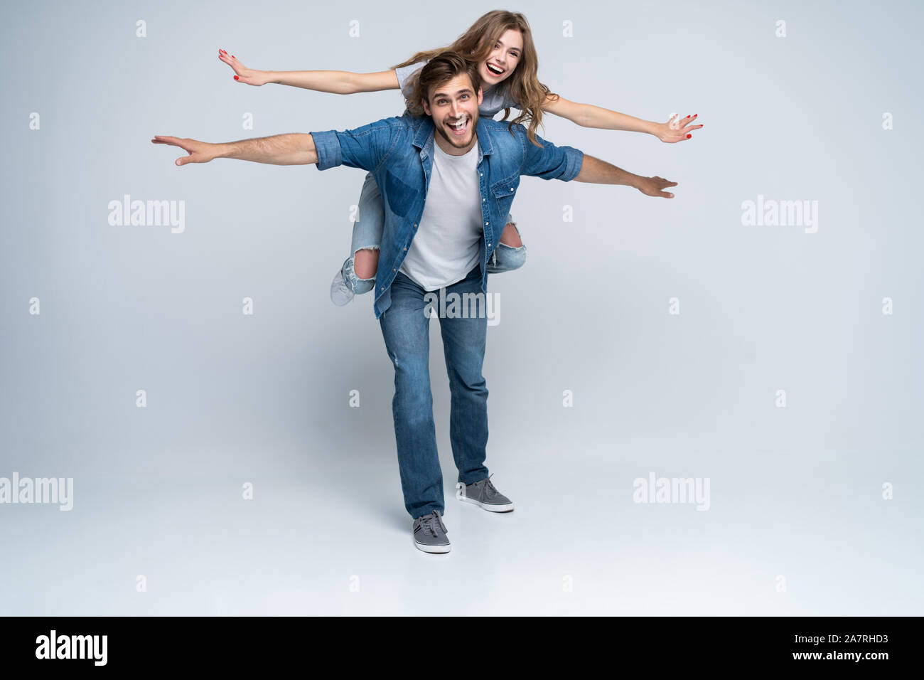 Cute portrait of couple. Guy rolls a girl on his back Stock Photo - Alamy