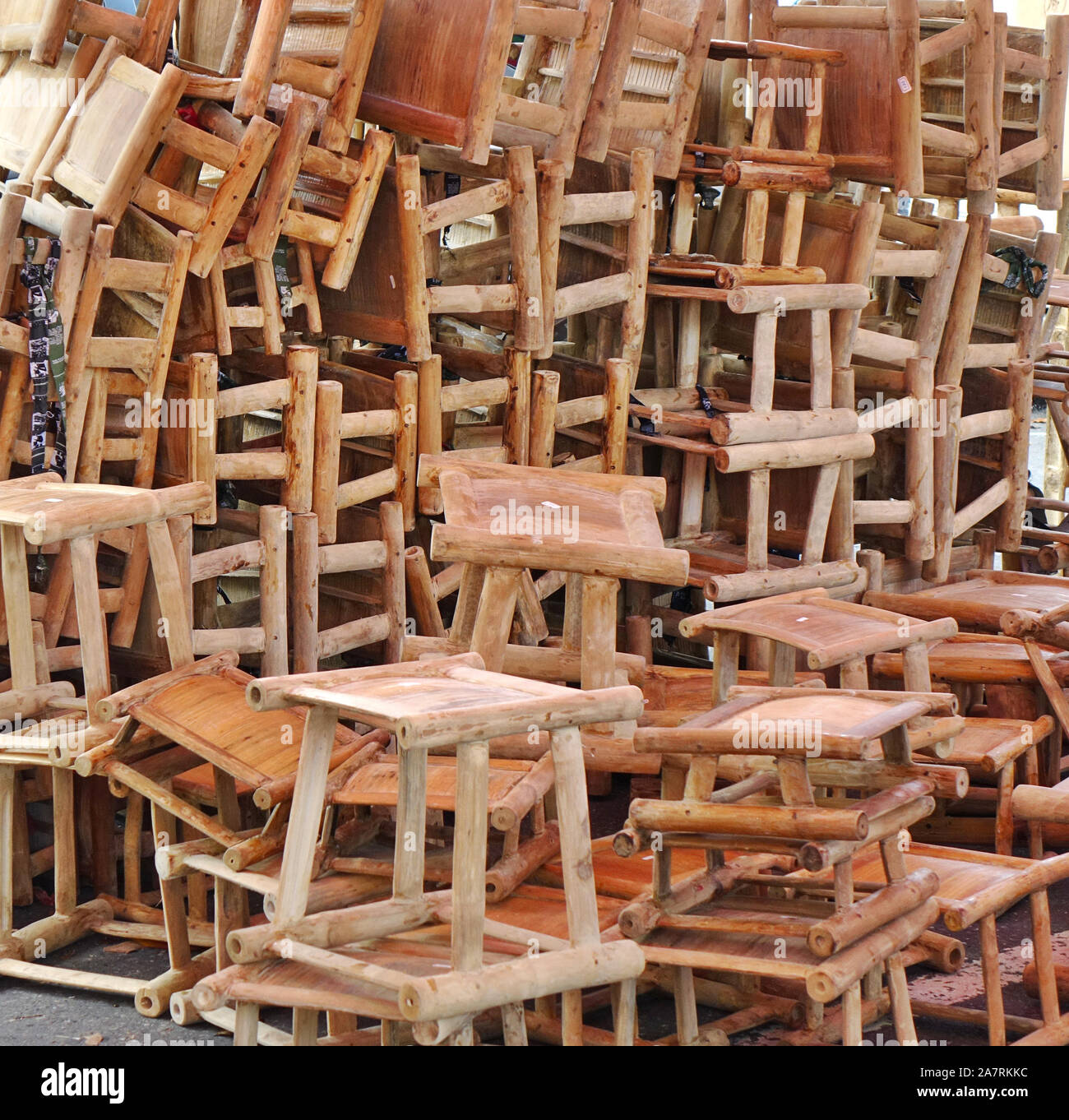 A street vendor is offering a large pile of sturdy bamboo stools Stock ...