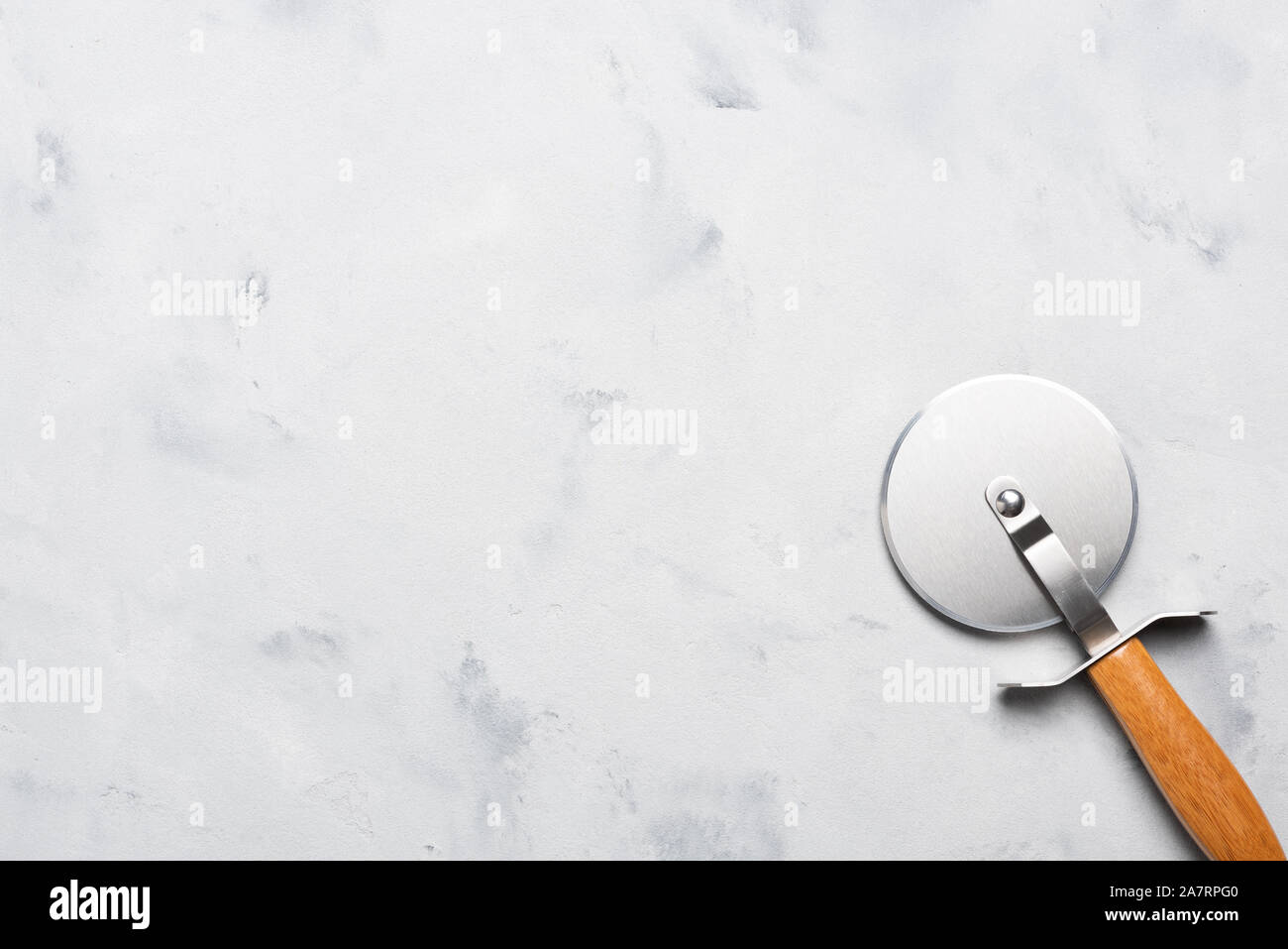 Pizza cutter with wooden handle on table top view Stock Photo - Alamy