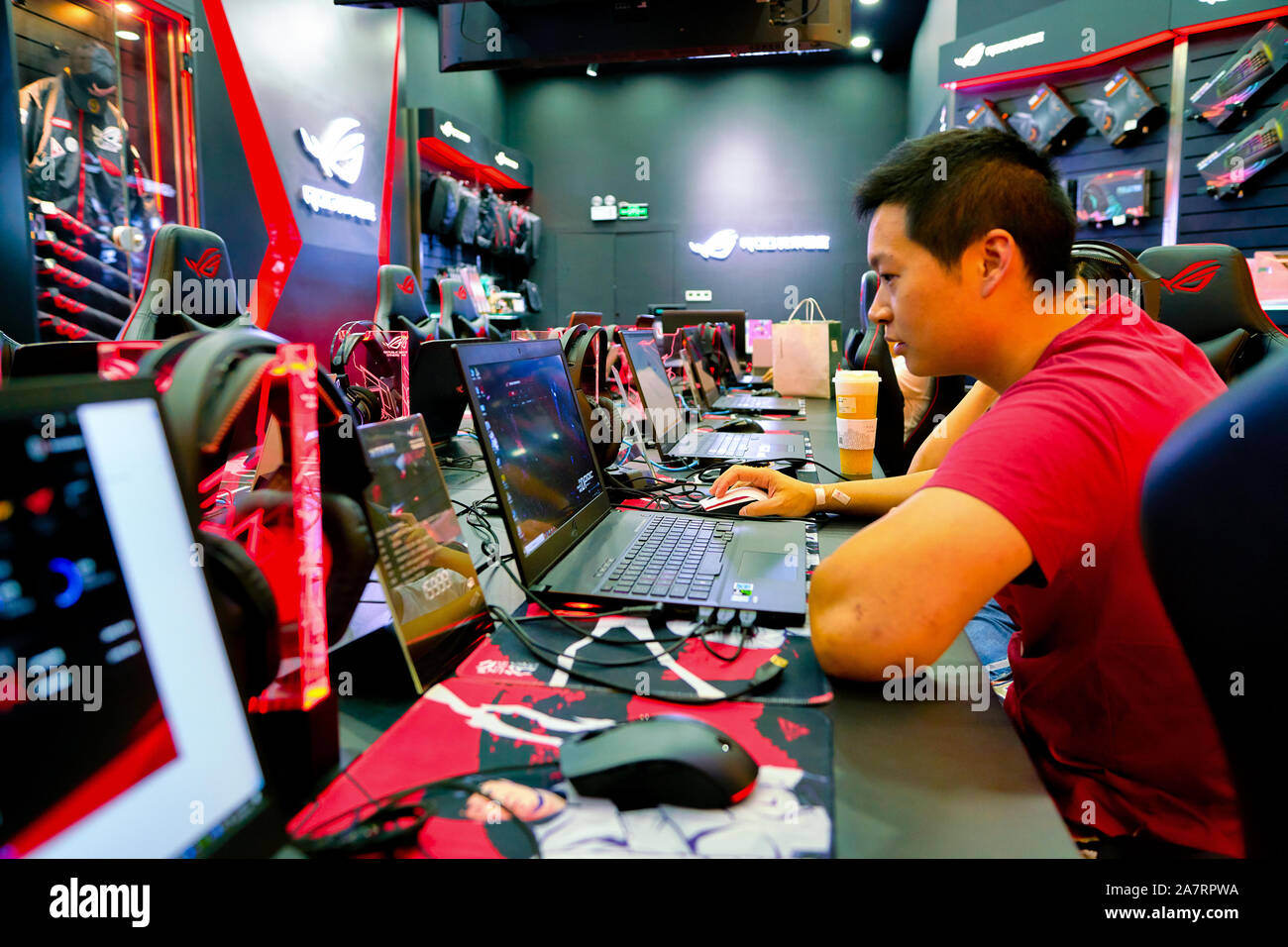 SHENZHEN, CHINA - CIRCA APRIL, 2019: a man using a laptop at Asus ROG ...
