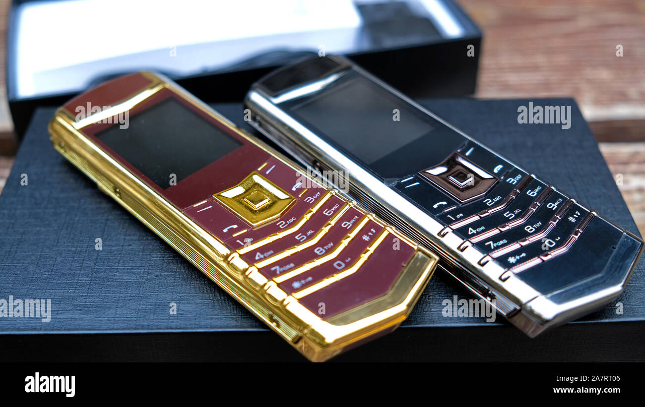 Brown and black luxury phone on the wood texture Stock Photo - Alamy
