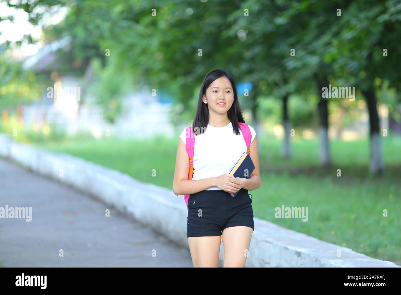 Young girl walking in the park are walking gait Stock Photo - Alamy