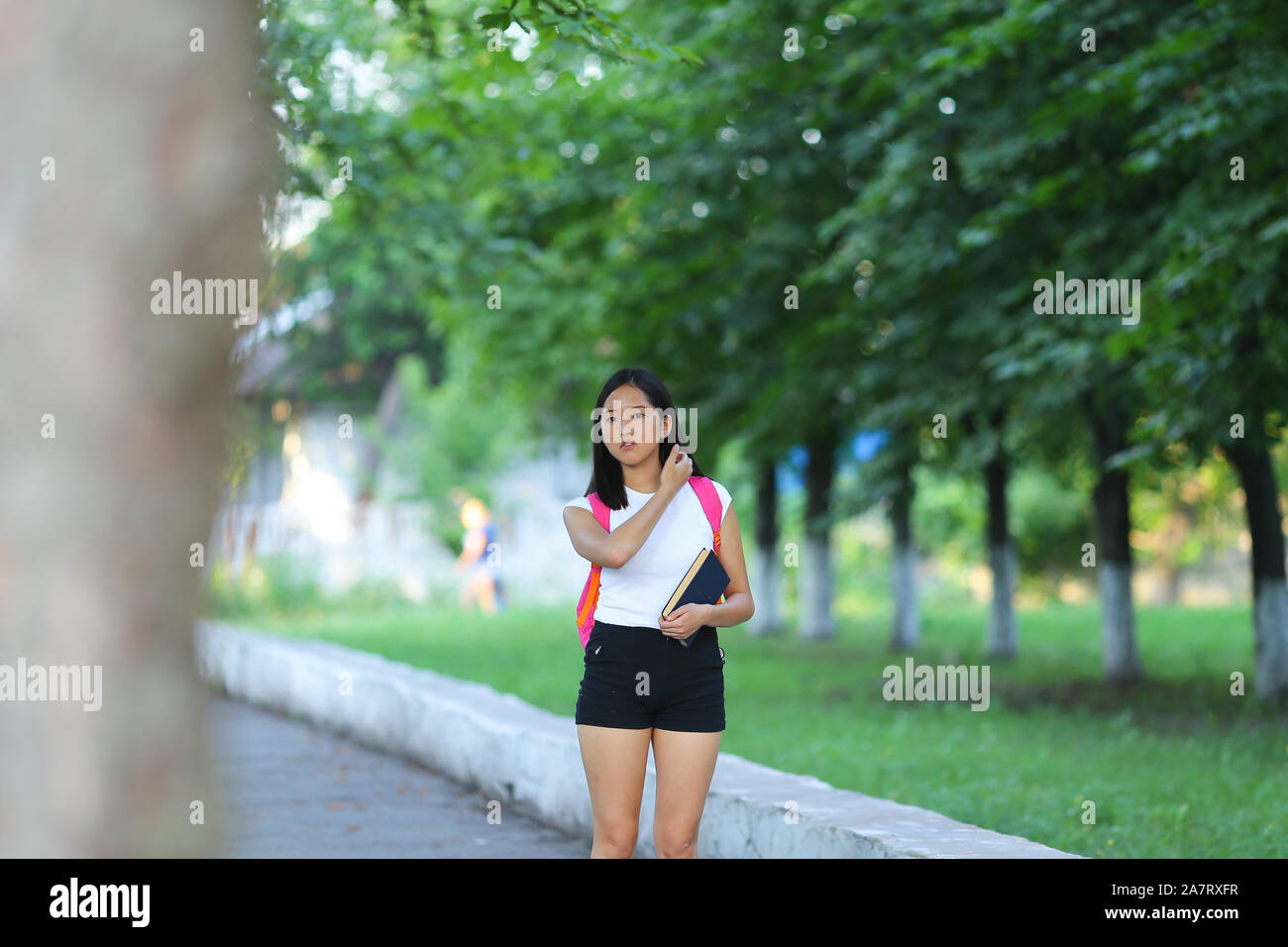 Young girl walking in the park are walking gait Stock Photo - Alamy