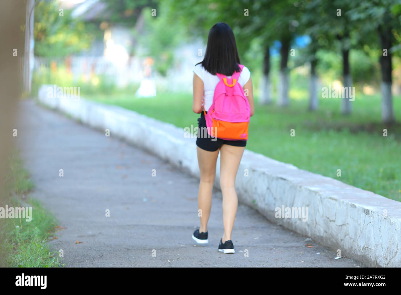 Young girl walking in the park are walking gait Stock Photo - Alamy