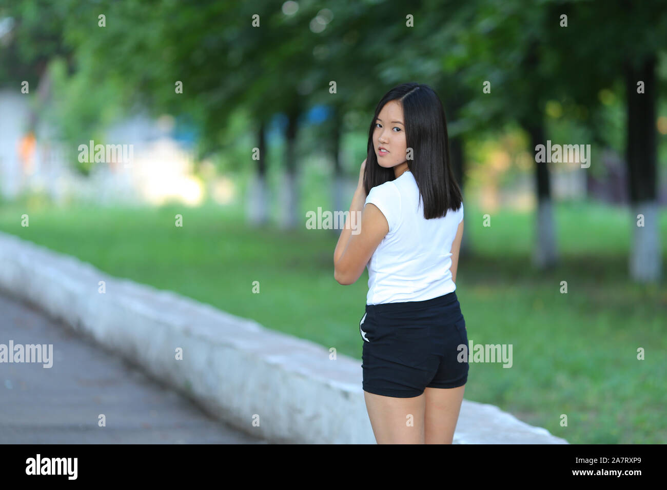 Young girl walking in the park are walking gait Stock Photo - Alamy