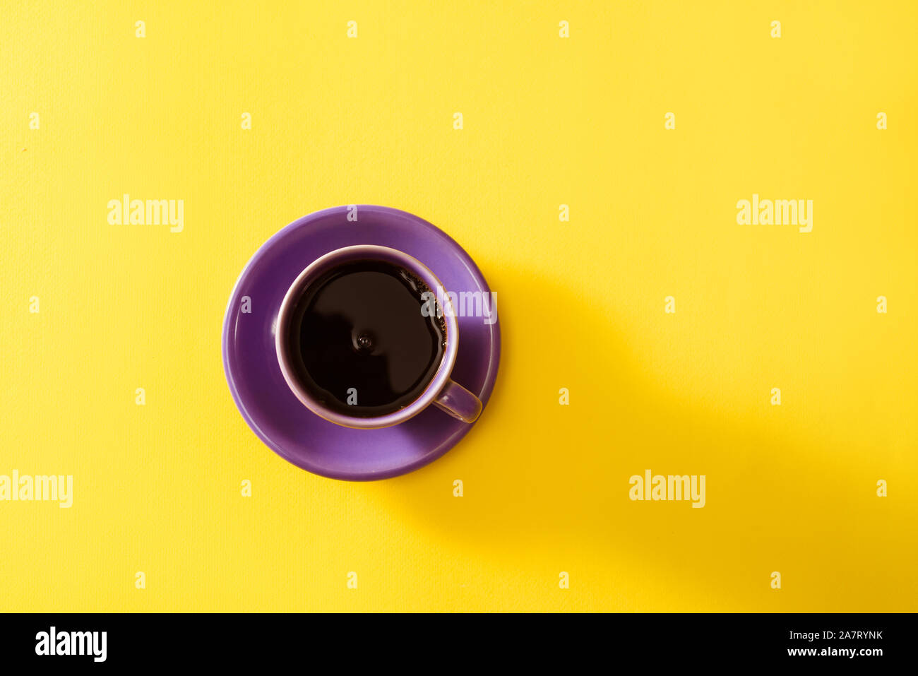 Purple cup of coffee on the yellow background Stock Photo - Alamy