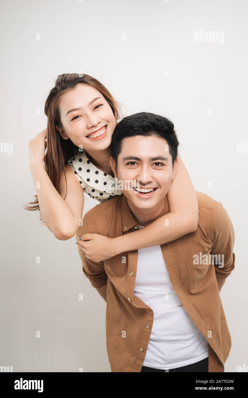 man carrying his lover on back, woman showing peace symbol over white ...