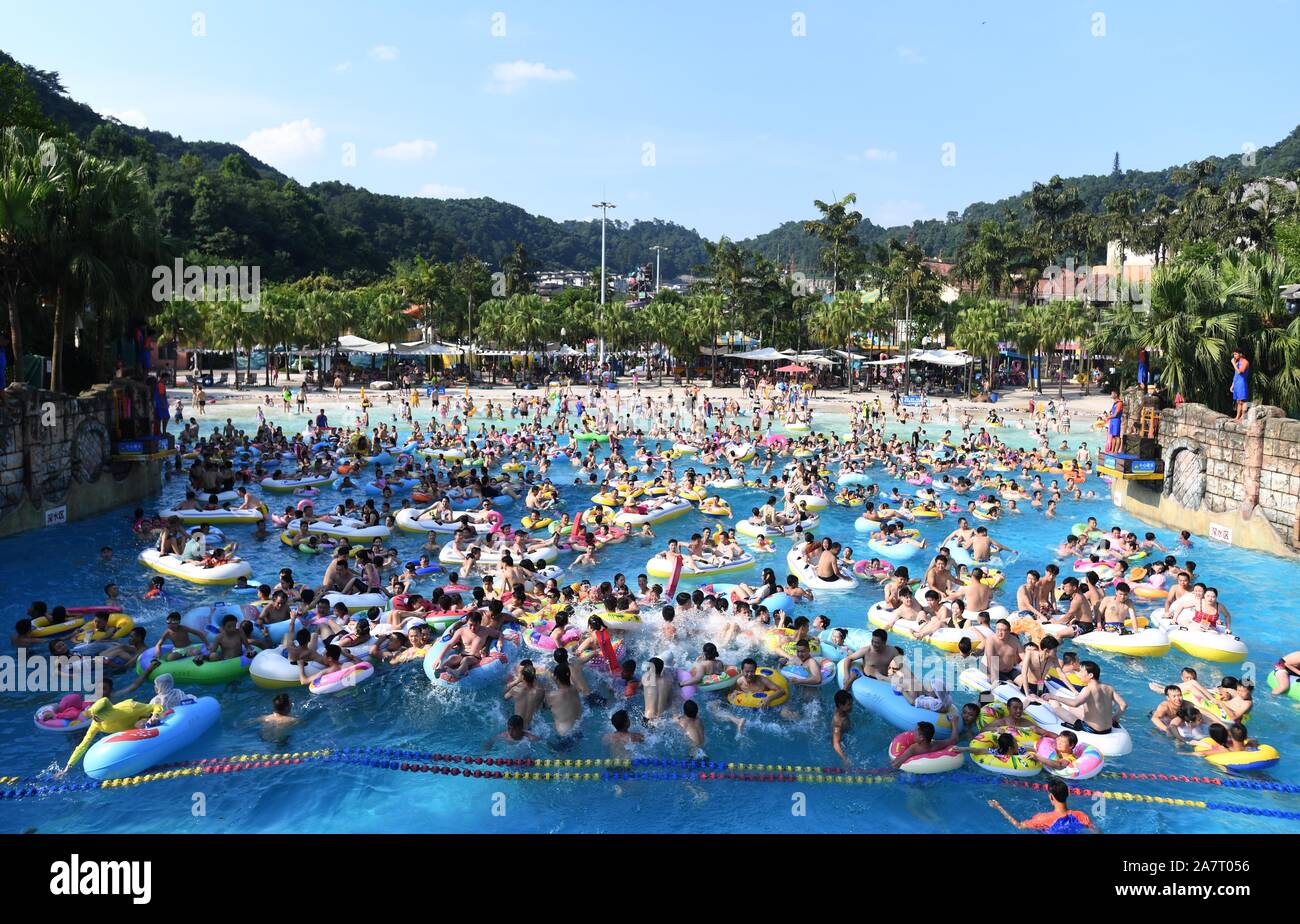 Chinese holidaymakers crowd a swimming pool at a water park to escape ...