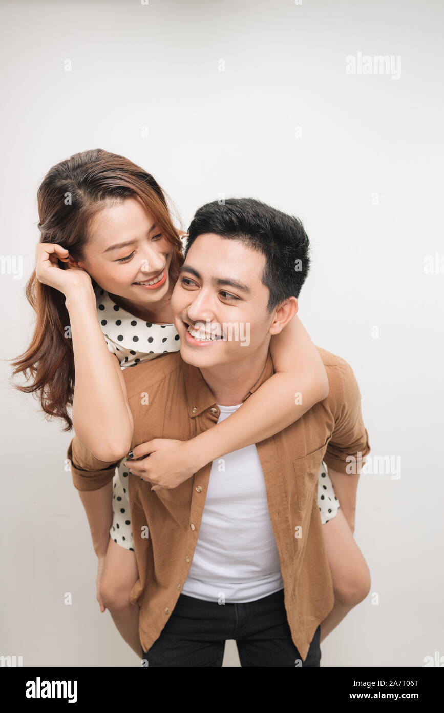 man carrying his lover on back, woman showing peace symbol over white ...