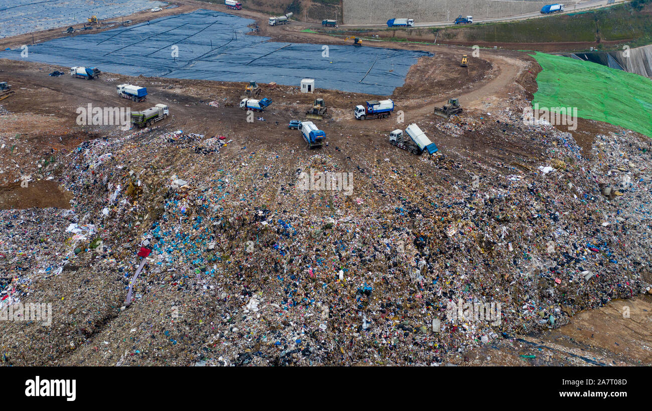 Chinese workers sort out and bury kitchen waste at the Jiangcungou ...